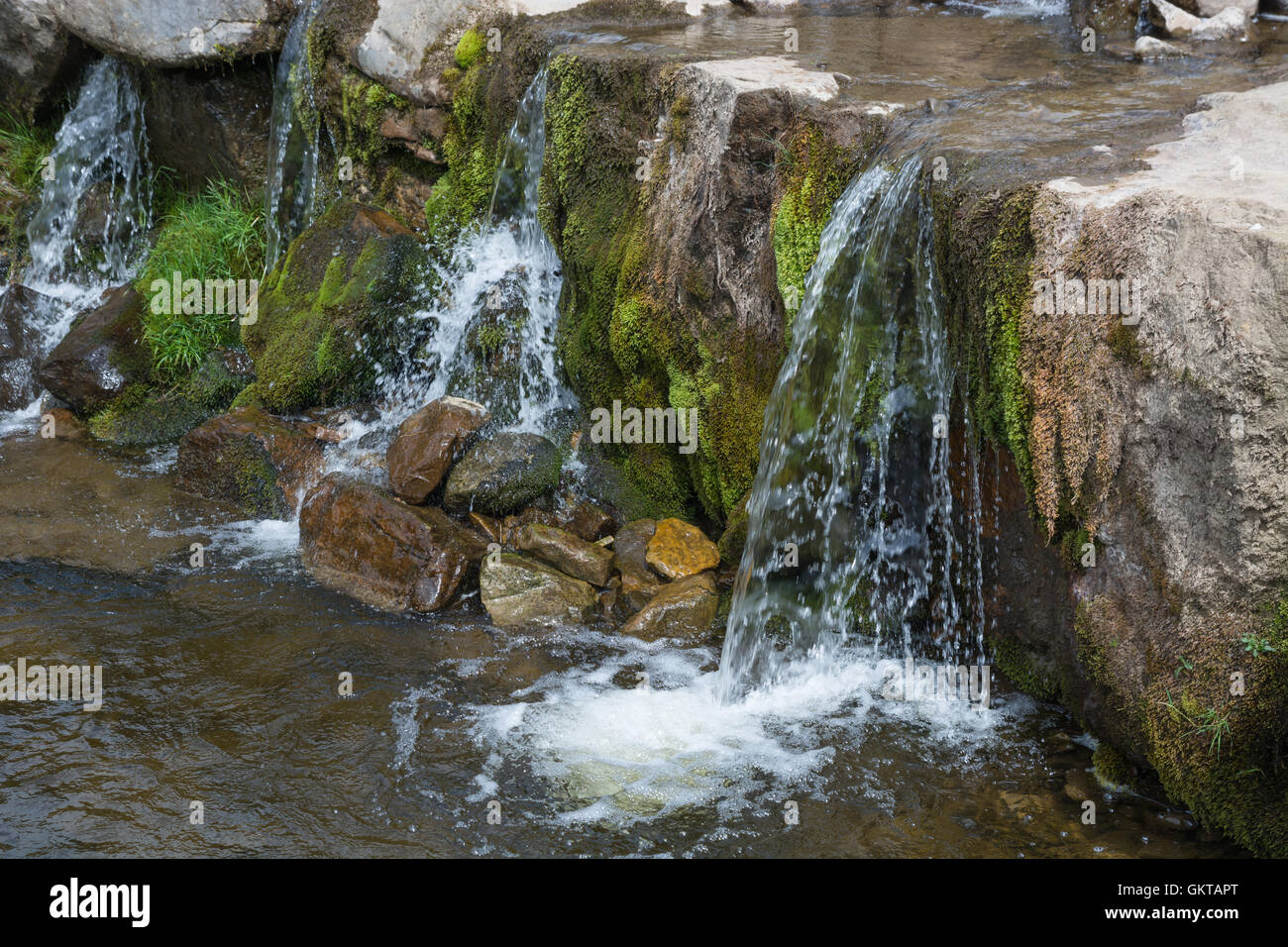 Flowing water in a small waterfall Stock Photo - Alamy