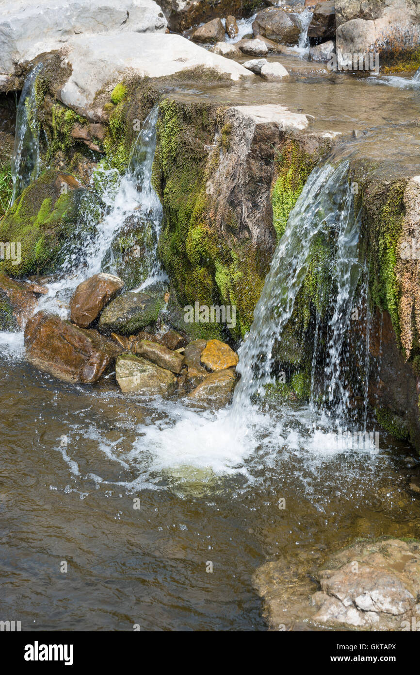 Flowing water in a small waterfall Stock Photo - Alamy
