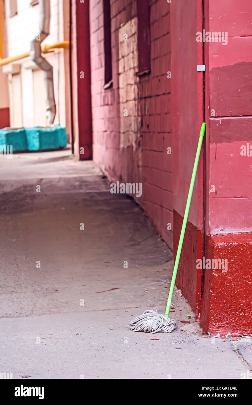 Lonely broom against gate at spring day Stock Photo - Alamy