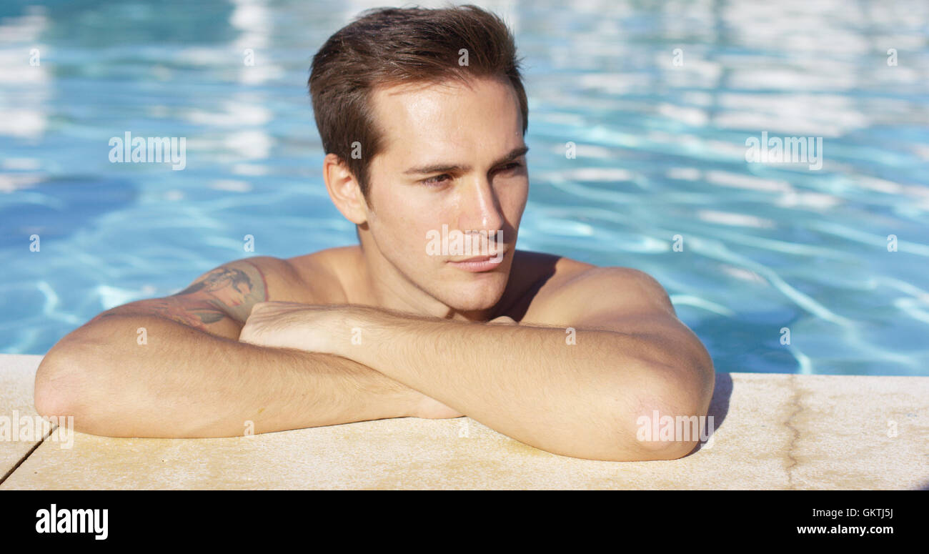 Man stands alone in pool and smiles at camera Stock Photo - Alamy
