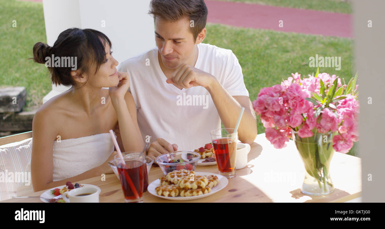 Couple talking at breakfast table outside Stock Photo - Alamy