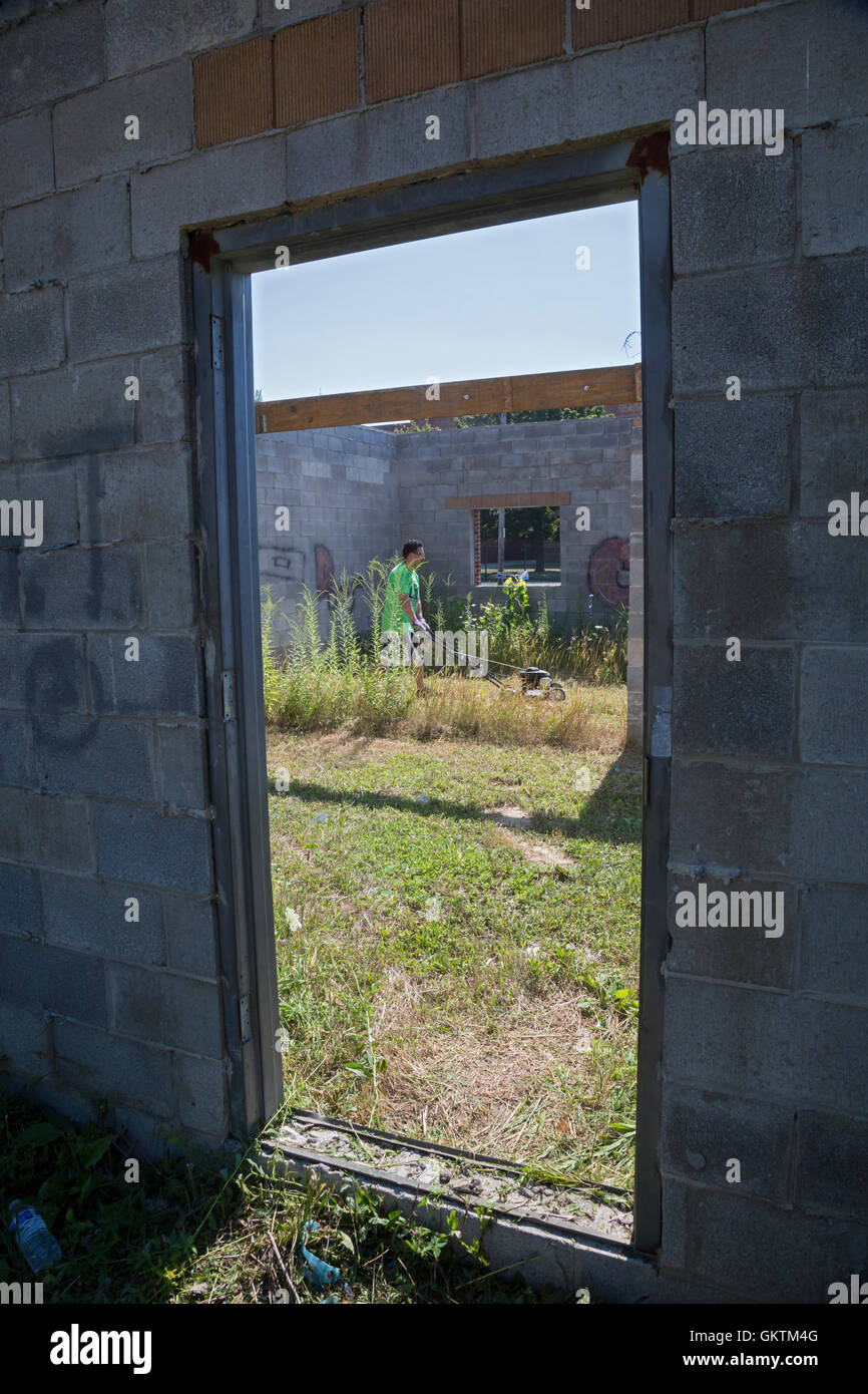 Detroit, Michigan - Volunteers clean up a distressed neighborhood ...