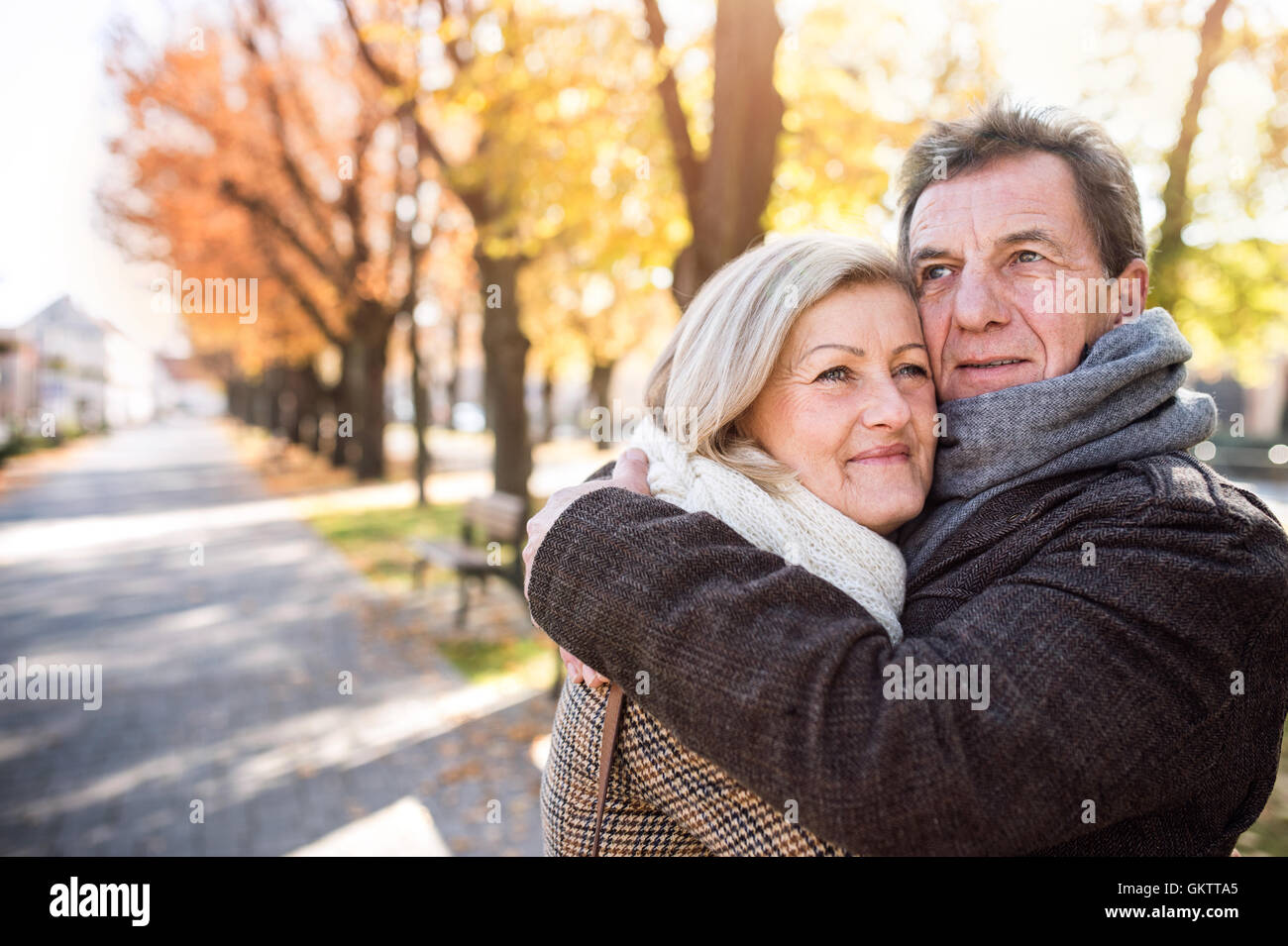 Beautiful Senior Couple Hugging In Park Sunny Autumn Nature Stock