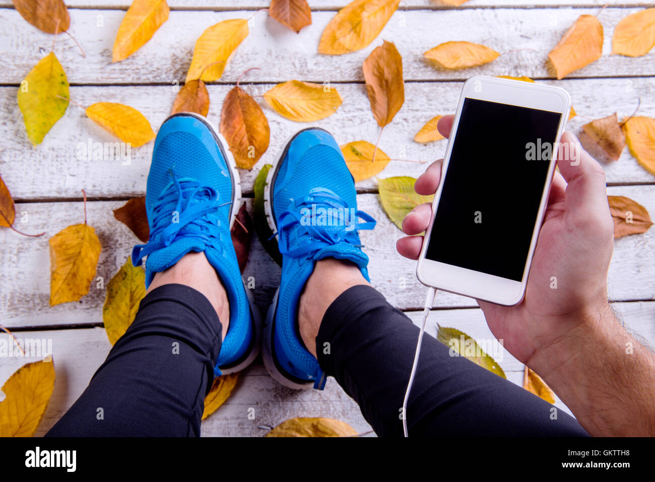 Hand holding smart phone legs hi-res stock photography and images - Alamy