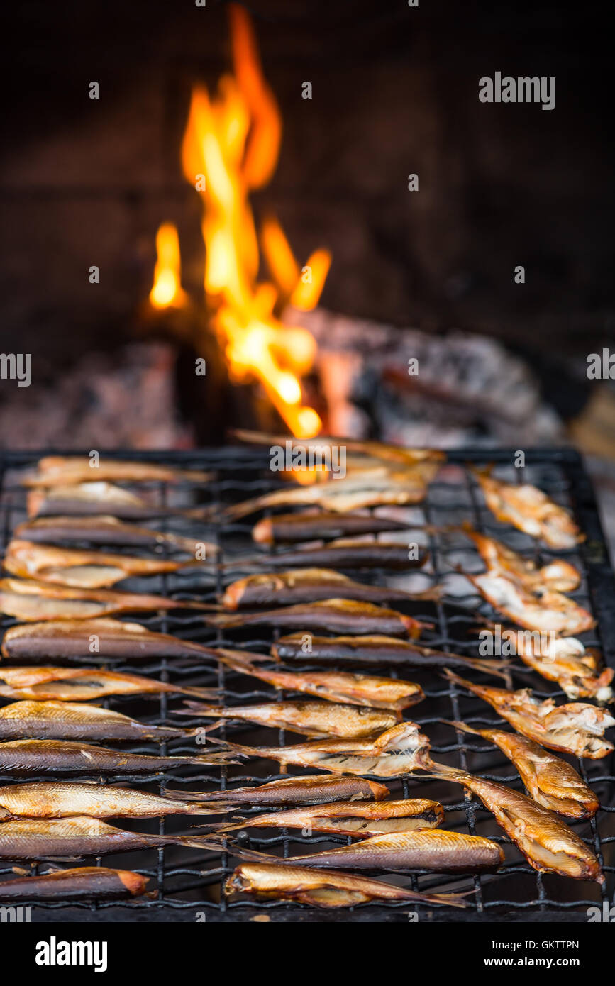 Closeup of smoked fish at the fire Stock Photo - Alamy