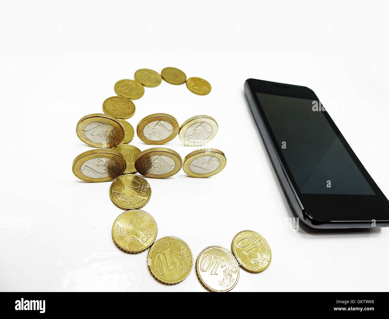 Smartphone with some coins Stock Photo - Alamy