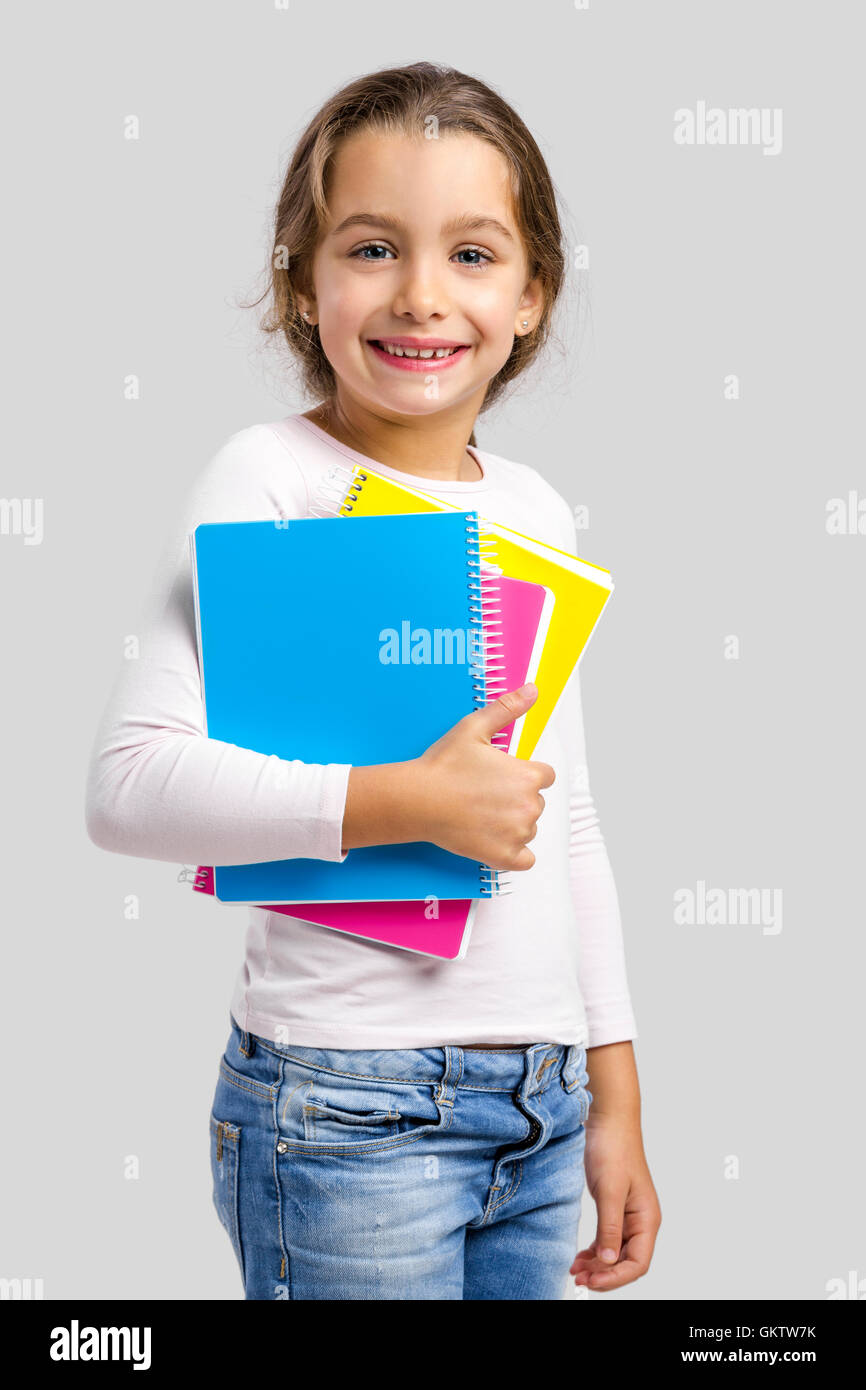Little schoolgirl holding books hi-res stock photography and images - Alamy