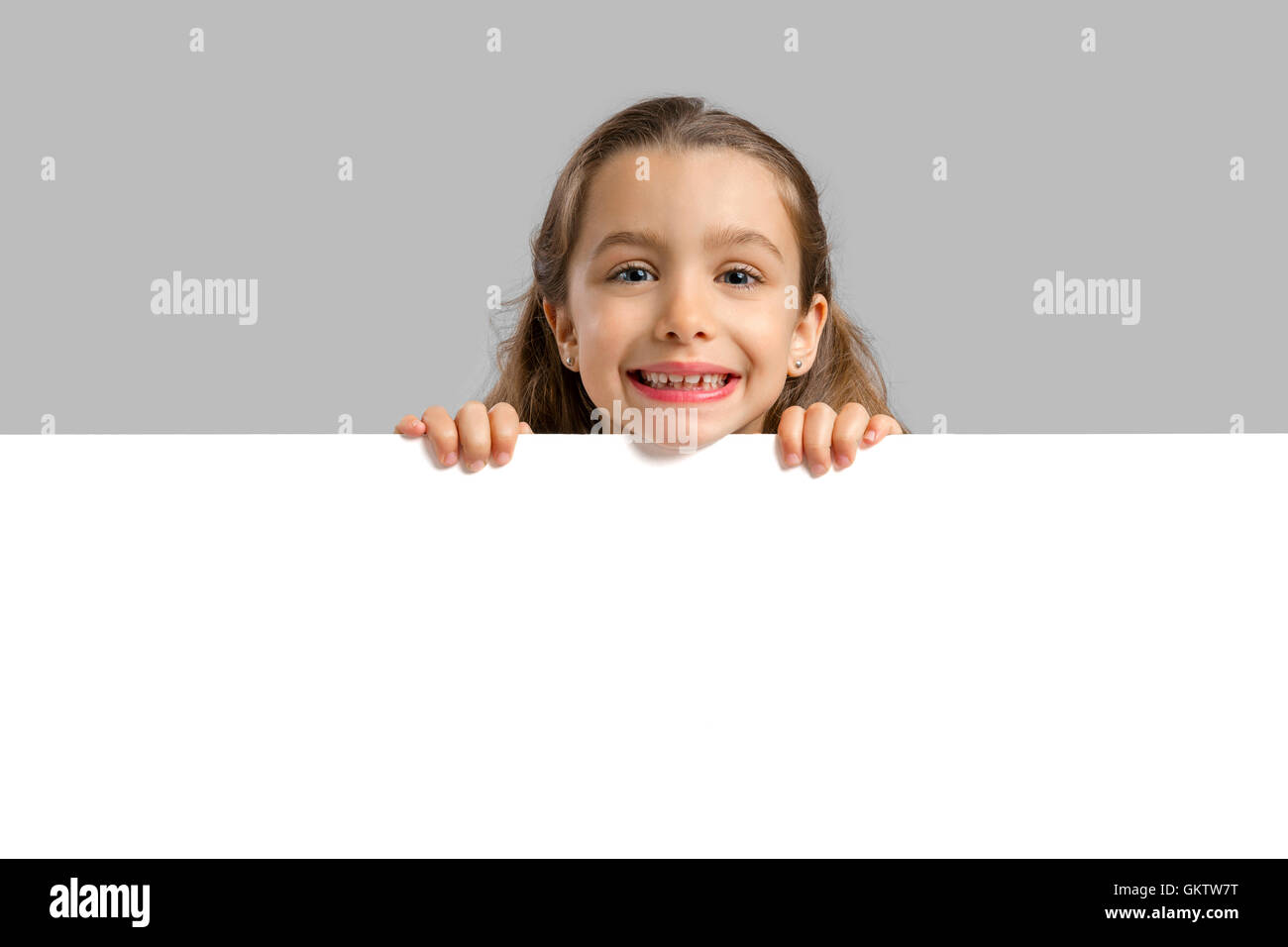 Cute little girl holding a blankboard, with copy space Stock Photo - Alamy