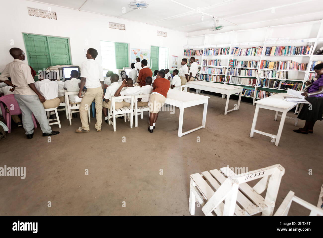 A group of children learning at a refurbished library at a school in ...