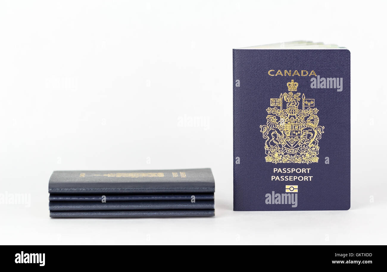 New biometric Canadian ePassport beside stack of old passports, with ...