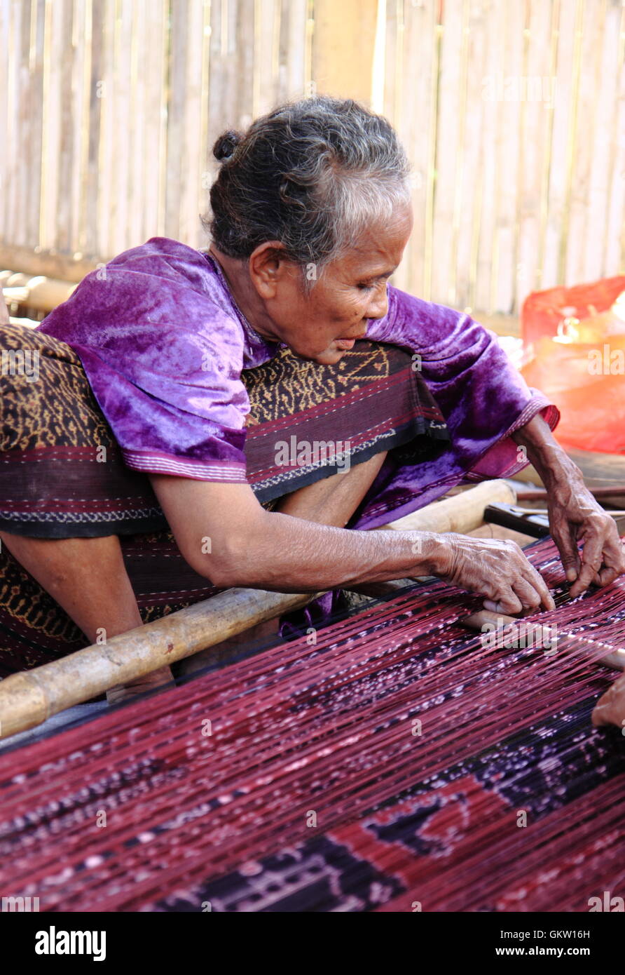 A local lady weaves in Moni village in Flores Indonesia Stock Photo - Alamy