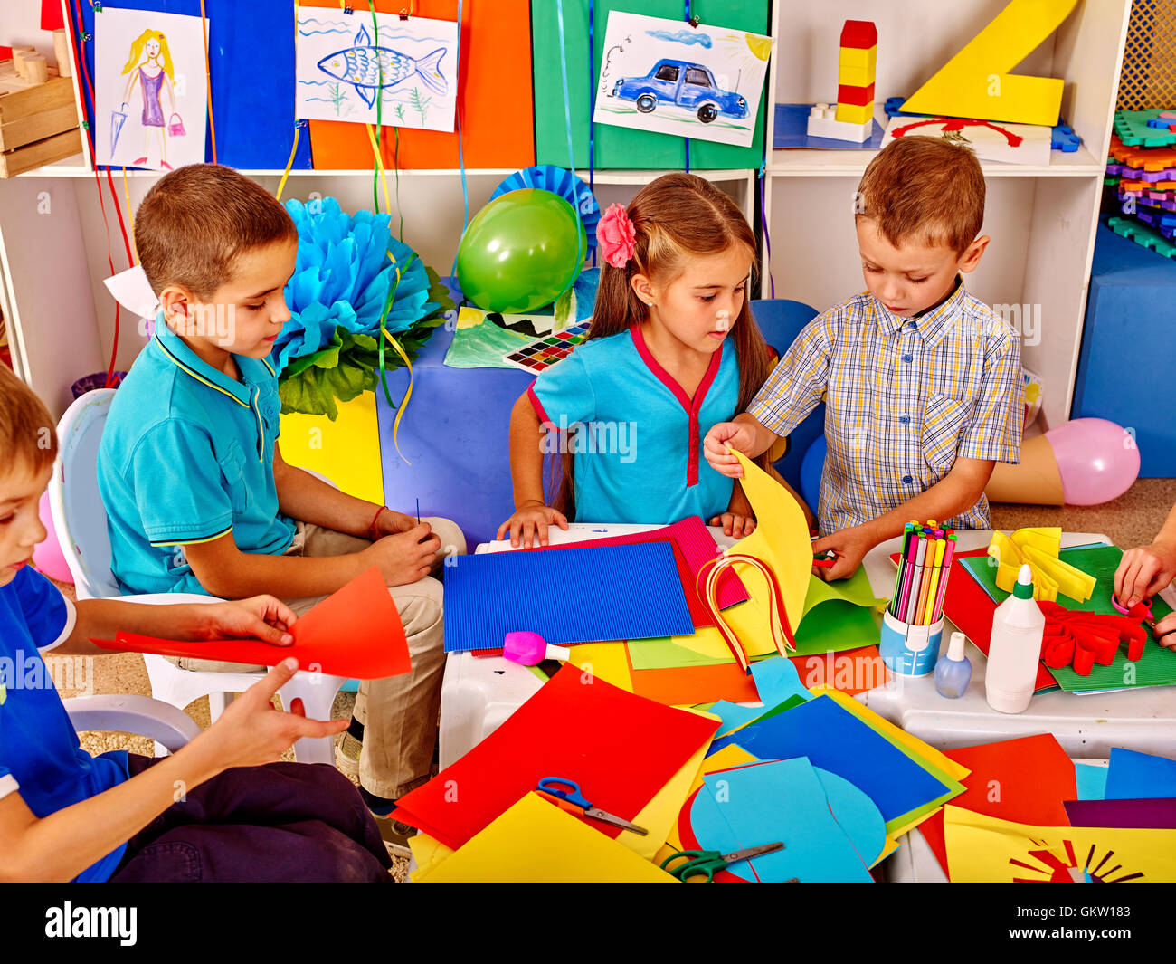 Kids holding colored paper on table in kindergarten Stock Photo - Alamy Kids holding colored paper on table in kindergarten Stock Photo - Alamy