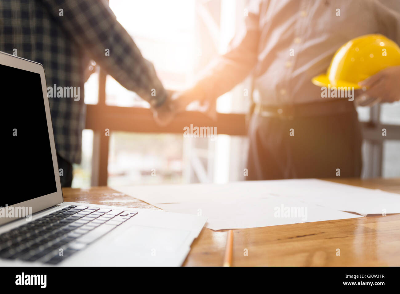 architect engineer shaking hands beside window - business teamwork ...