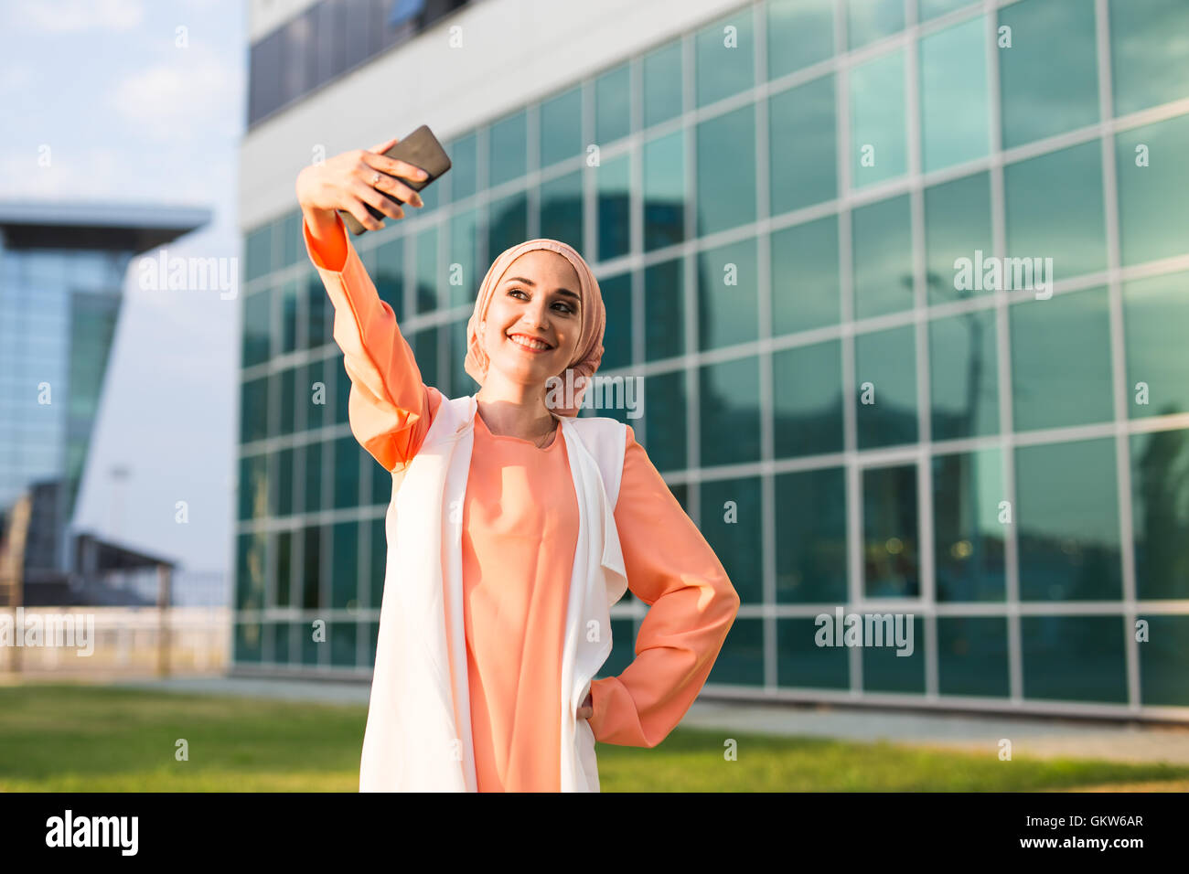 Young muslim woman take self portrait Stock Photo - Alamy