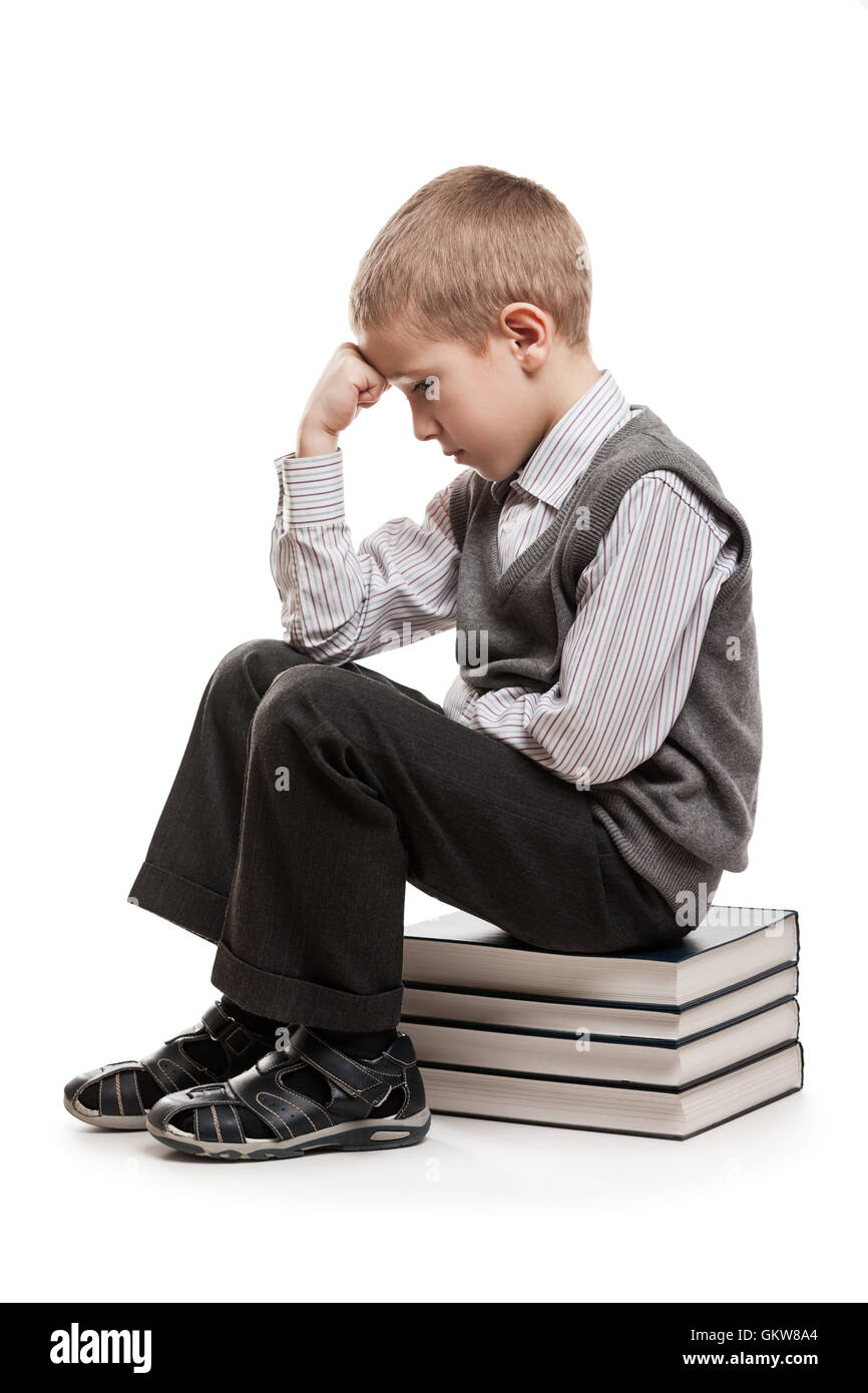 Thinker child sitting on reading books Stock Photo - Alamy