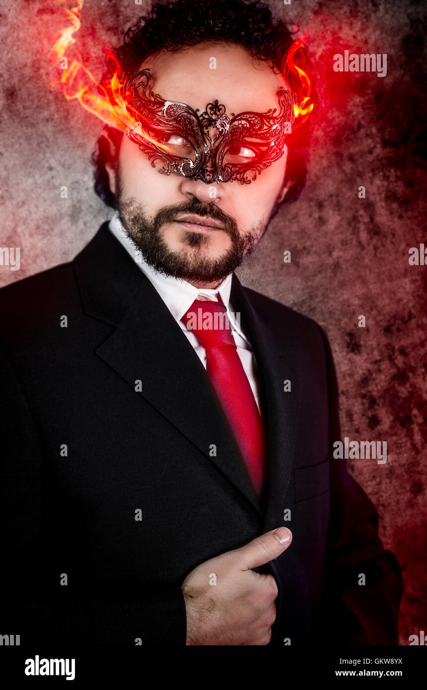 concept evil man with fiery eyes and Venetian mask wearing black Stock ...