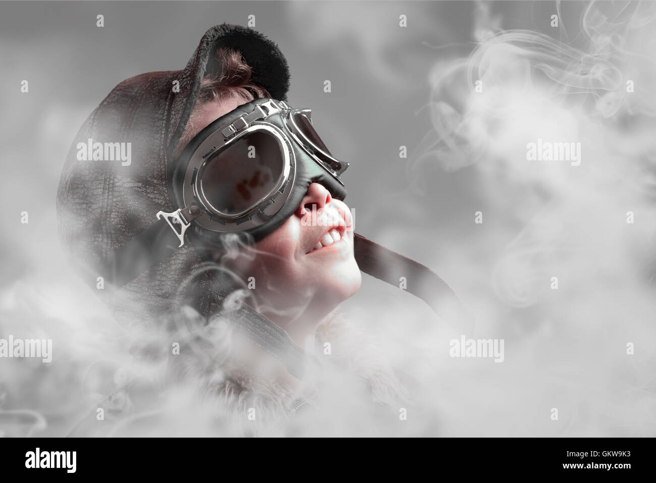 Boy pilot smiling into smoke Stock Photo - Alamy