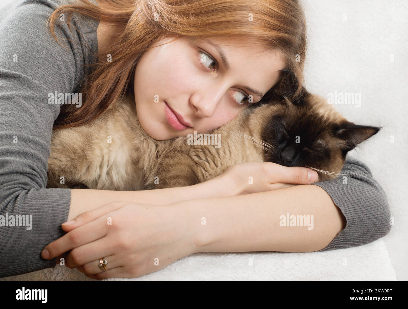 cute girl affectionately hugging kitten Stock Photo - Alamy