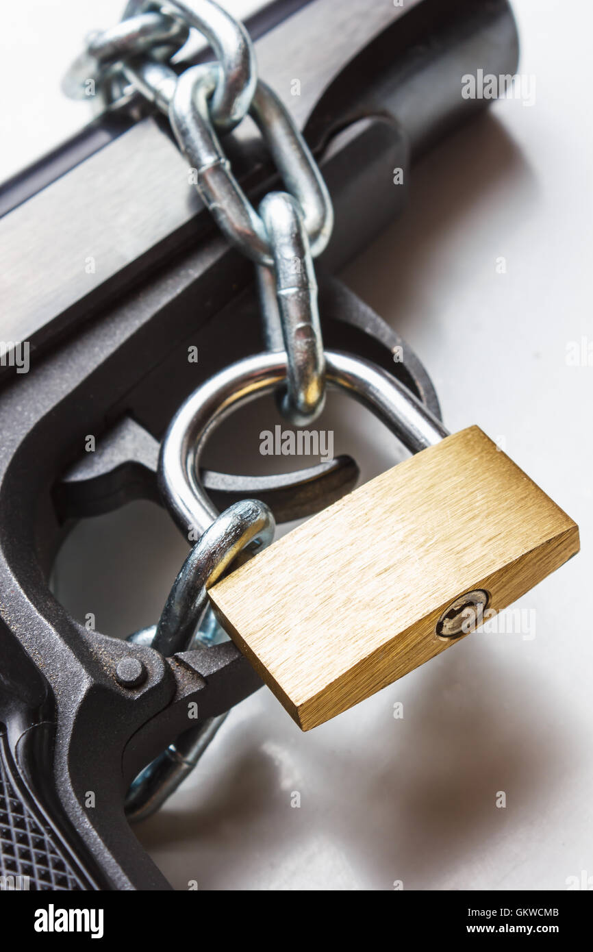 the gun, chain and closed padlock Stock Photo - Alamy