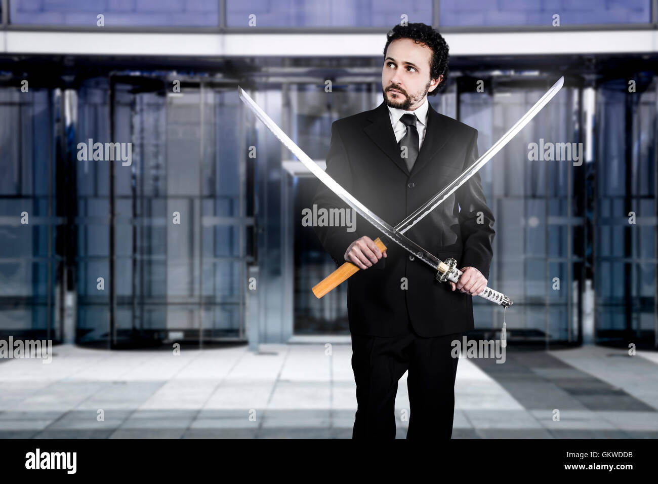 Businessman with two Japanese swords at the entrance of an offic Stock ...
