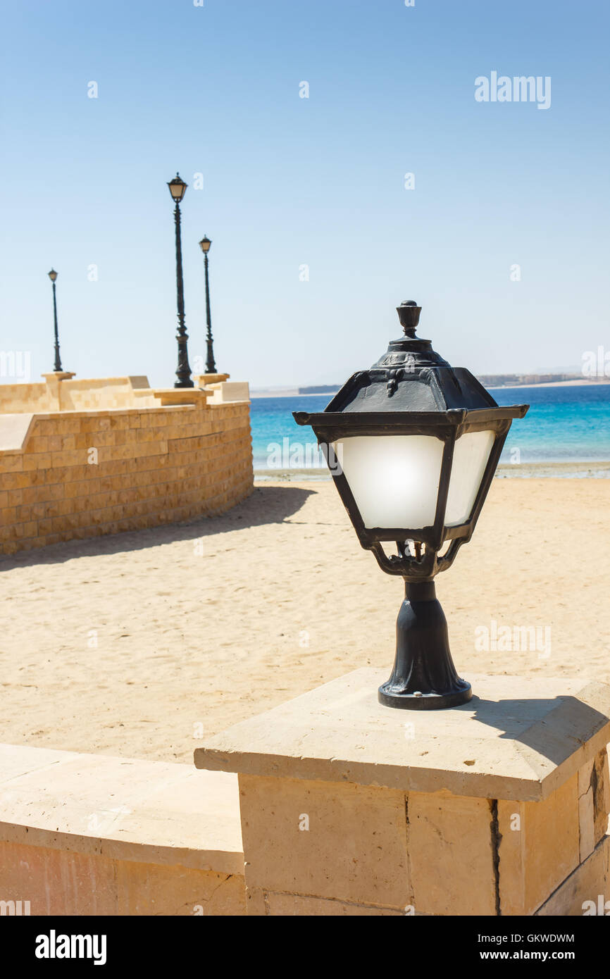 The arched stone colonnade with lanterns Stock Photo - Alamy