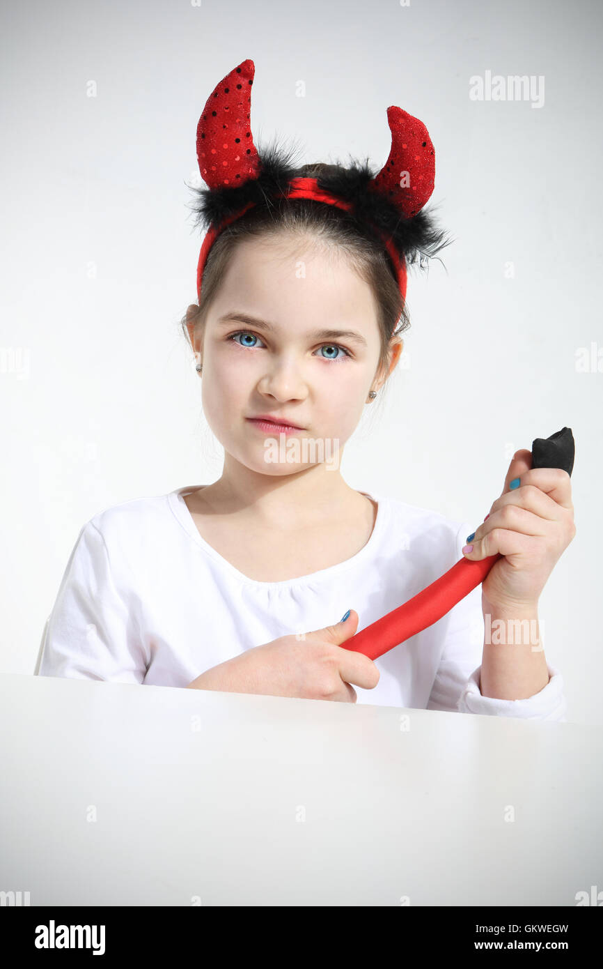 Little girl dressed as pretty imp in studio Stock Photo - Alamy