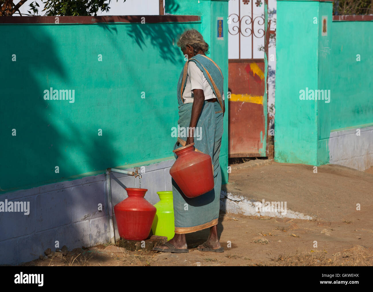 Old woman getting water from the village tap in Koonthakulam, Tamil ...