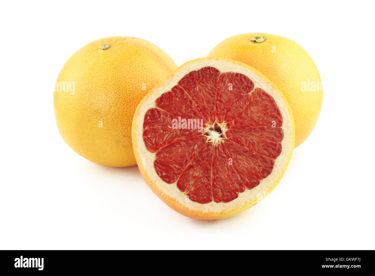 Two grapefruits and half Stock Photo - Alamy