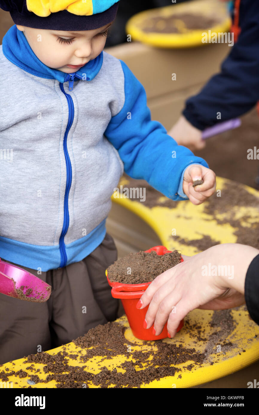 Boy Playing in Sandbox Stock Photo - Alamy
