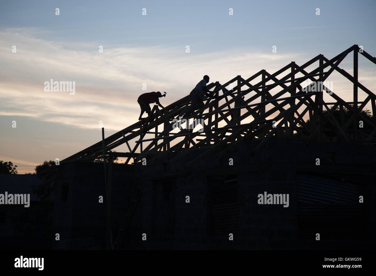 Man working on house roof hi-res stock photography and images - Alamy