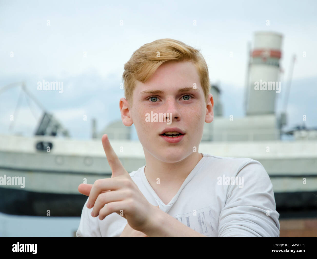 Teenager boy looking up with his finger up making a statement Stock ...