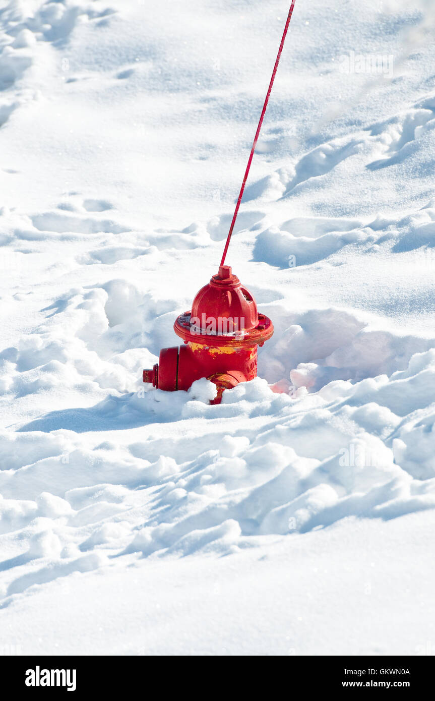 Red fire hydrant sunk in snow Stock Photo - Alamy