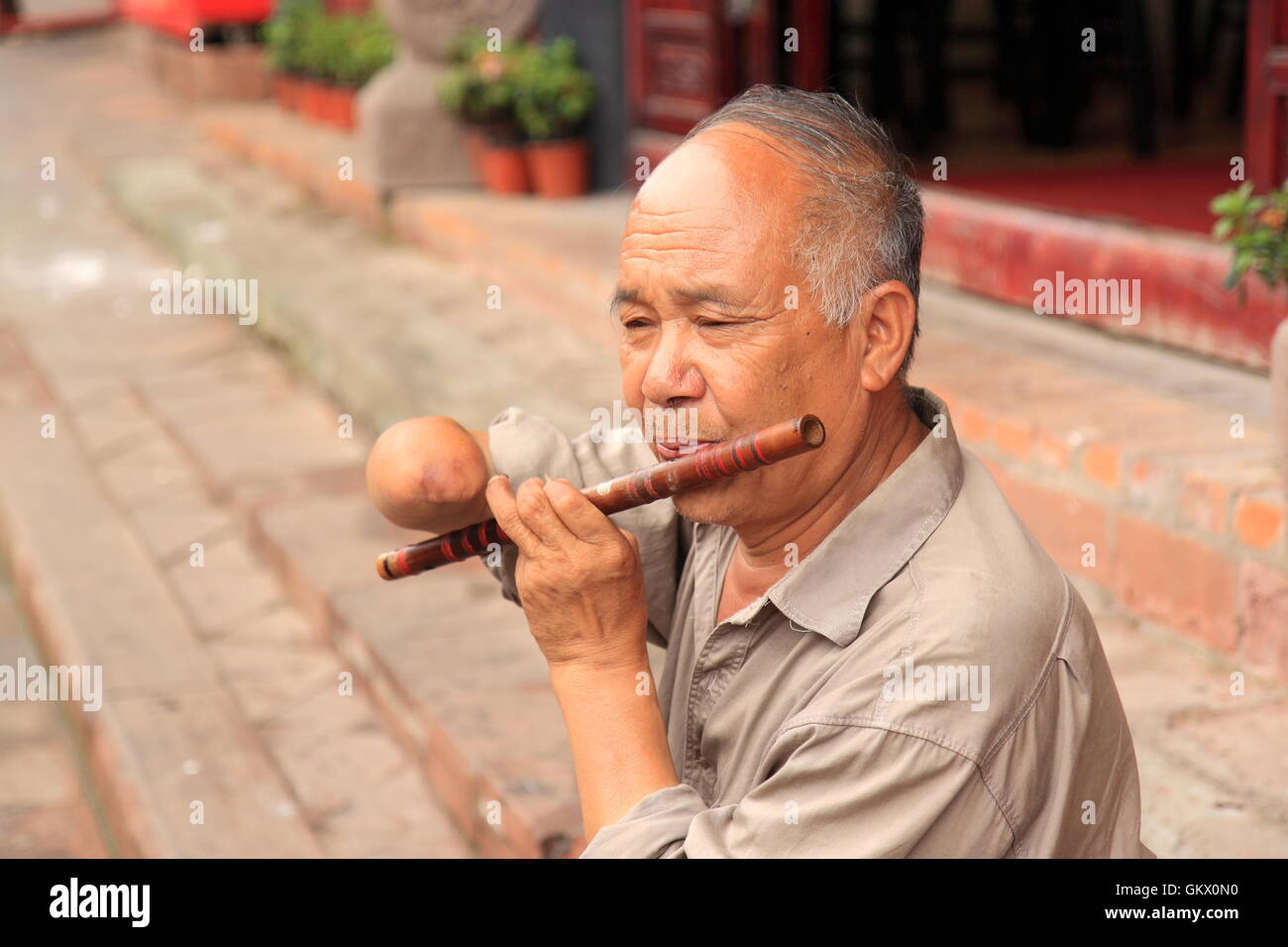 Handicapped man plays traditional Chinese instrument in Hakka Luodai ...