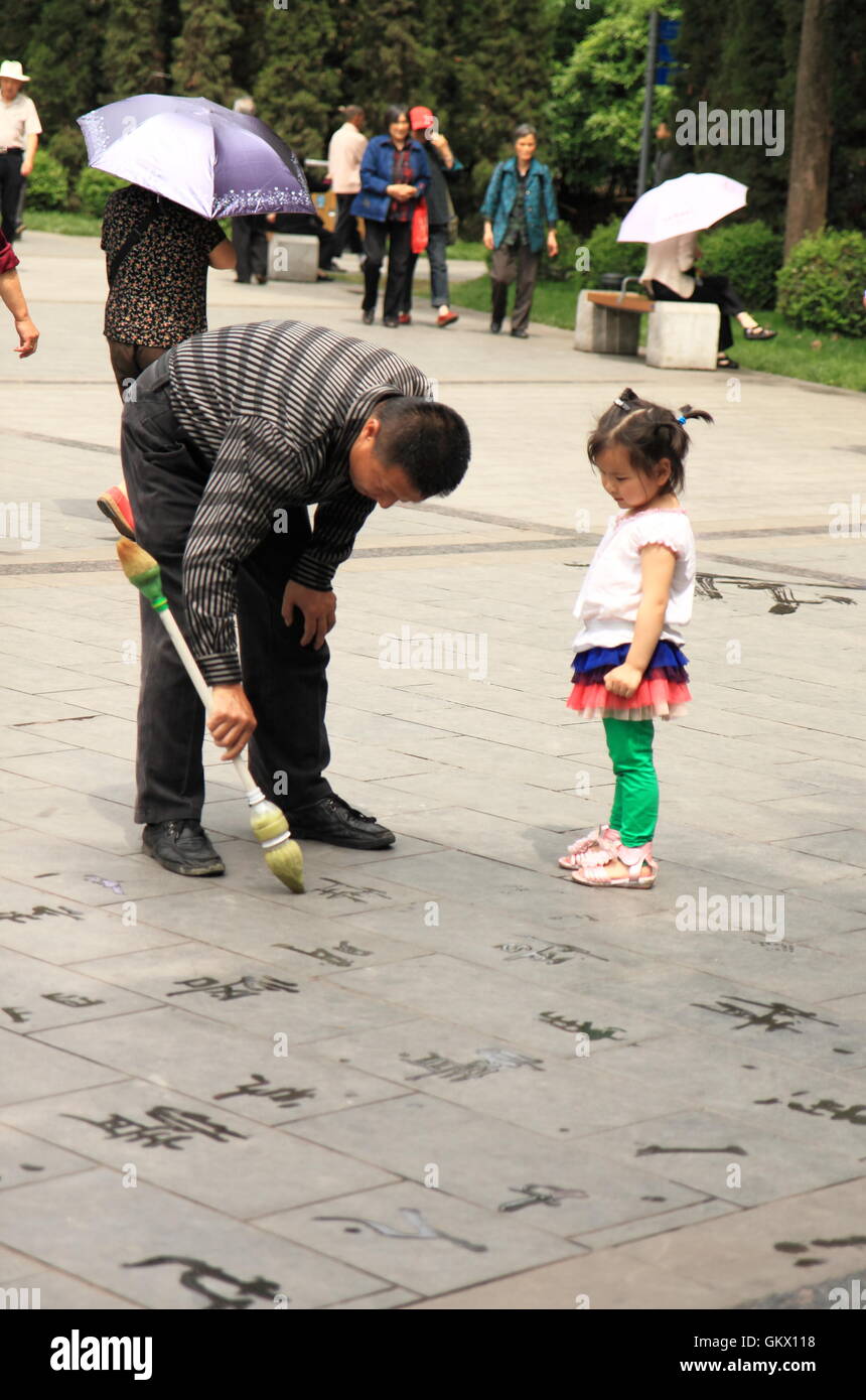 A man writes Chinese characters at the Peoples Park in Chengdu China ...