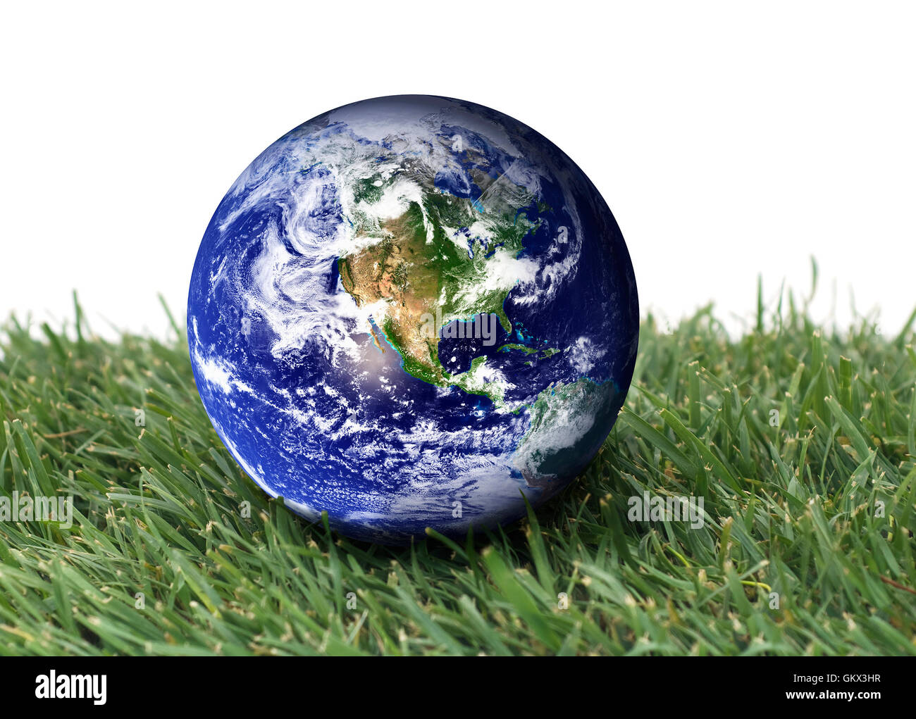 Planet earth over green grass on a isolated background. The planet ...