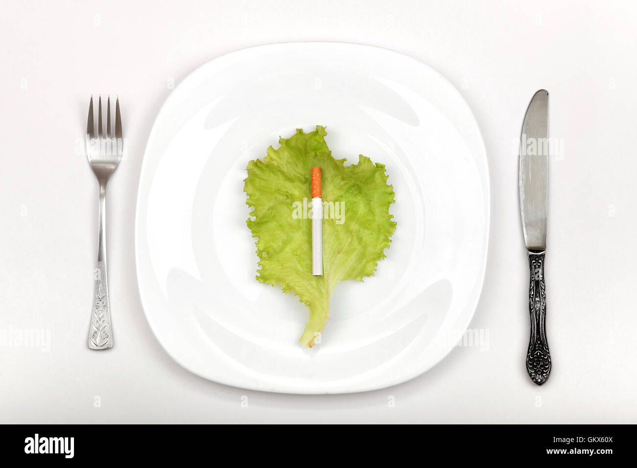 Cigarette On Dinner Plate Stock Photo - Alamy