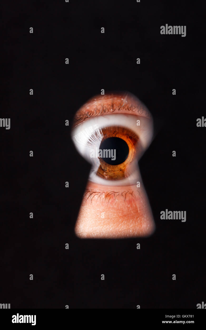 Woman looking through keyhole hi-res stock photography and images - Alamy