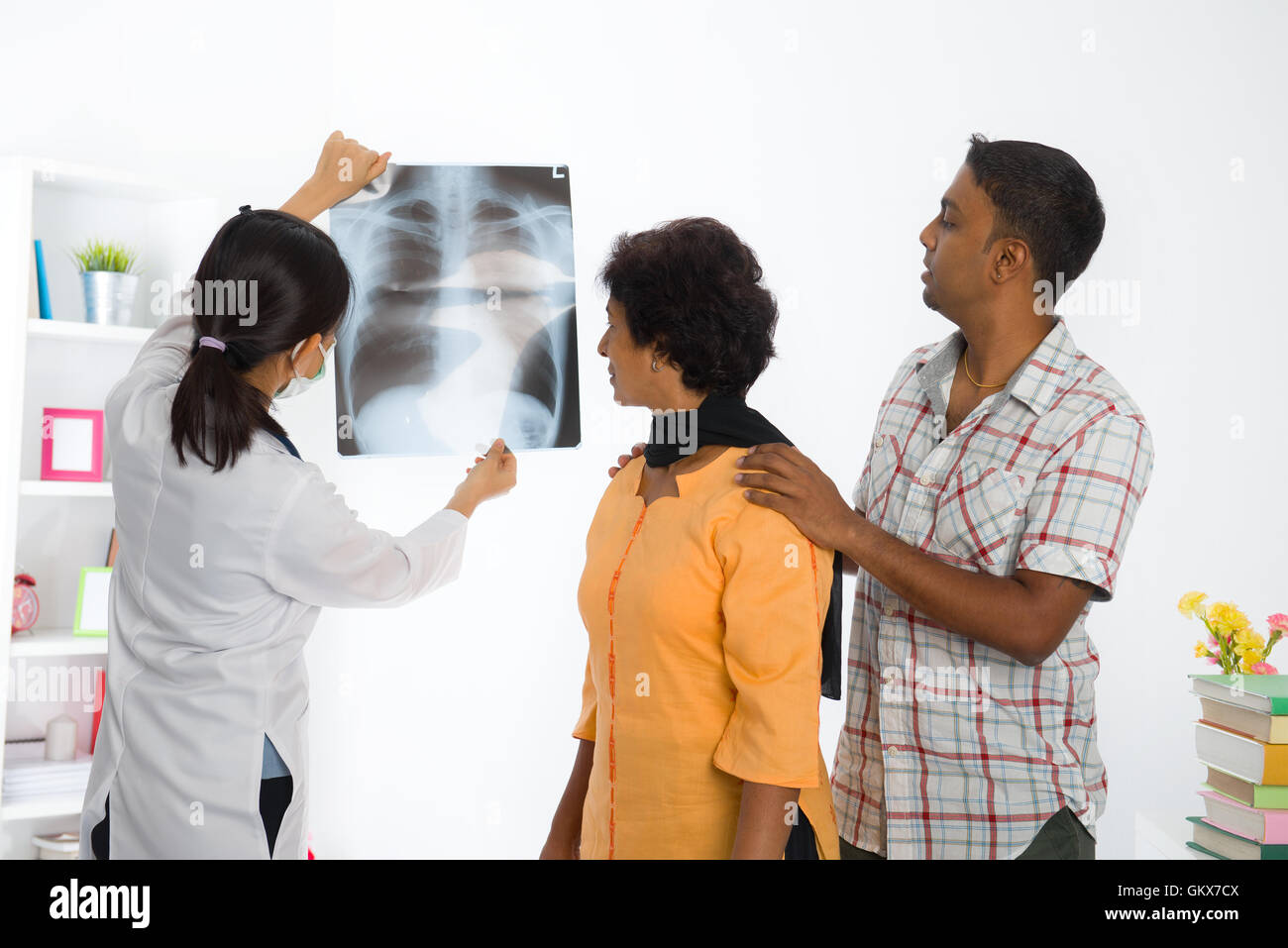 indian family senior female doing x-ray scan with asian doctor Stock ...