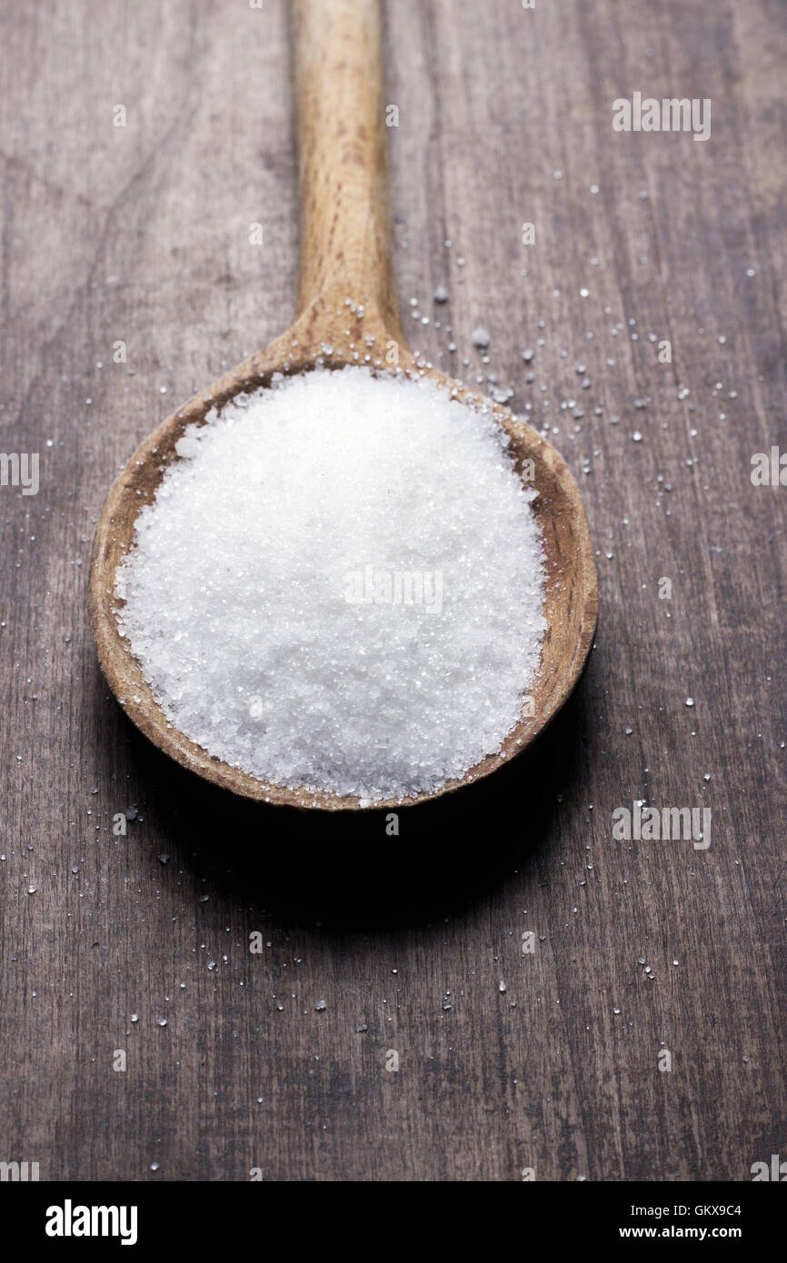 sugar in a wooden spoon Stock Photo - Alamy