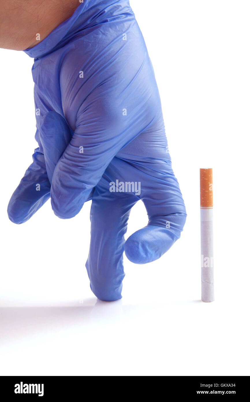 Gloved hand throwing cigarette Quit smoking metaphor Stock Photo - Alamy