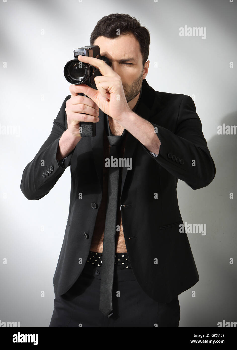 Attractive man taking photo Stock Photo - Alamy