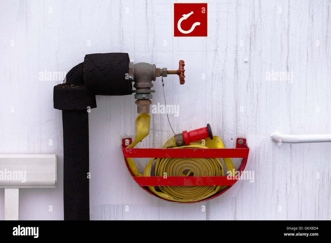 Fire hose on water outlet ready for fire emergency Stock Photo - Alamy