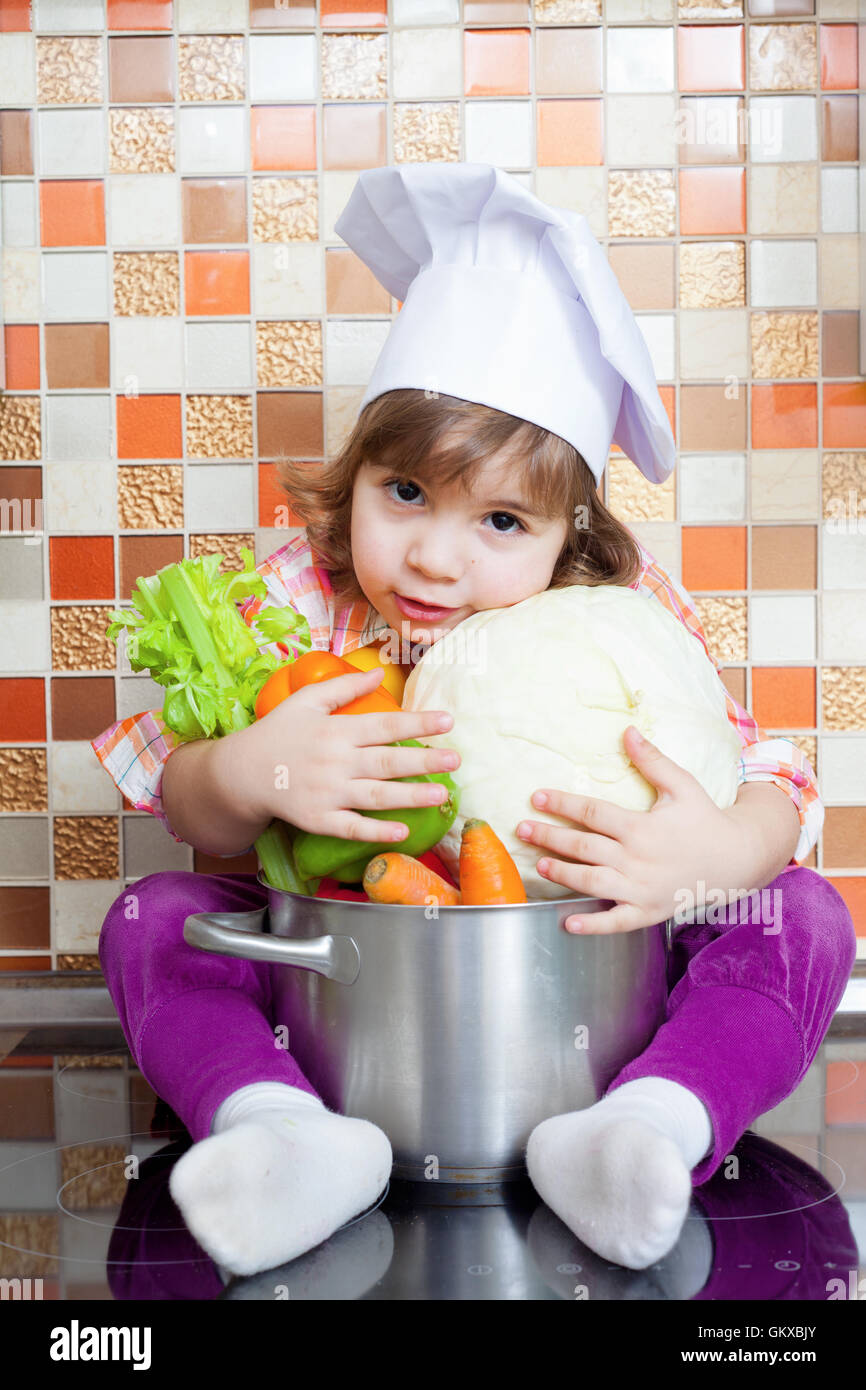 Baby cook with vegetables Stock Photo - Alamy