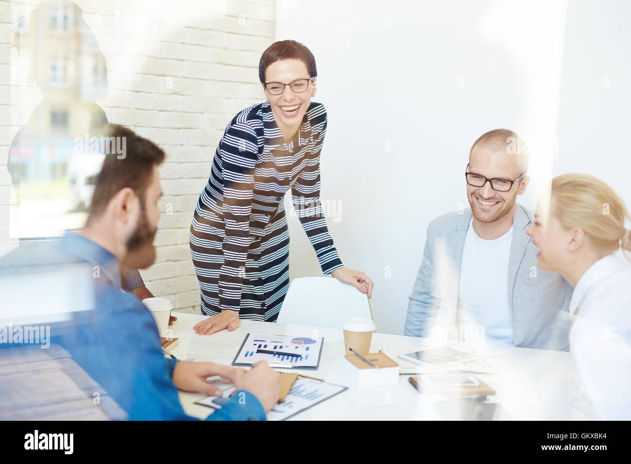Successful managers laughing during discussion of work Stock Photo - Alamy