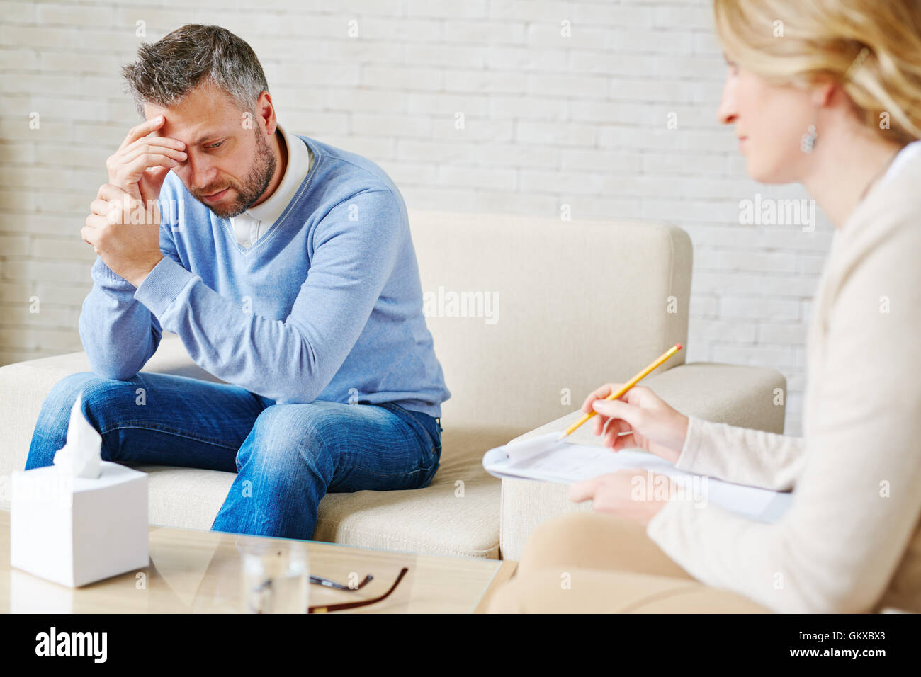 Sad man visiting his psychologist Stock Photo - Alamy