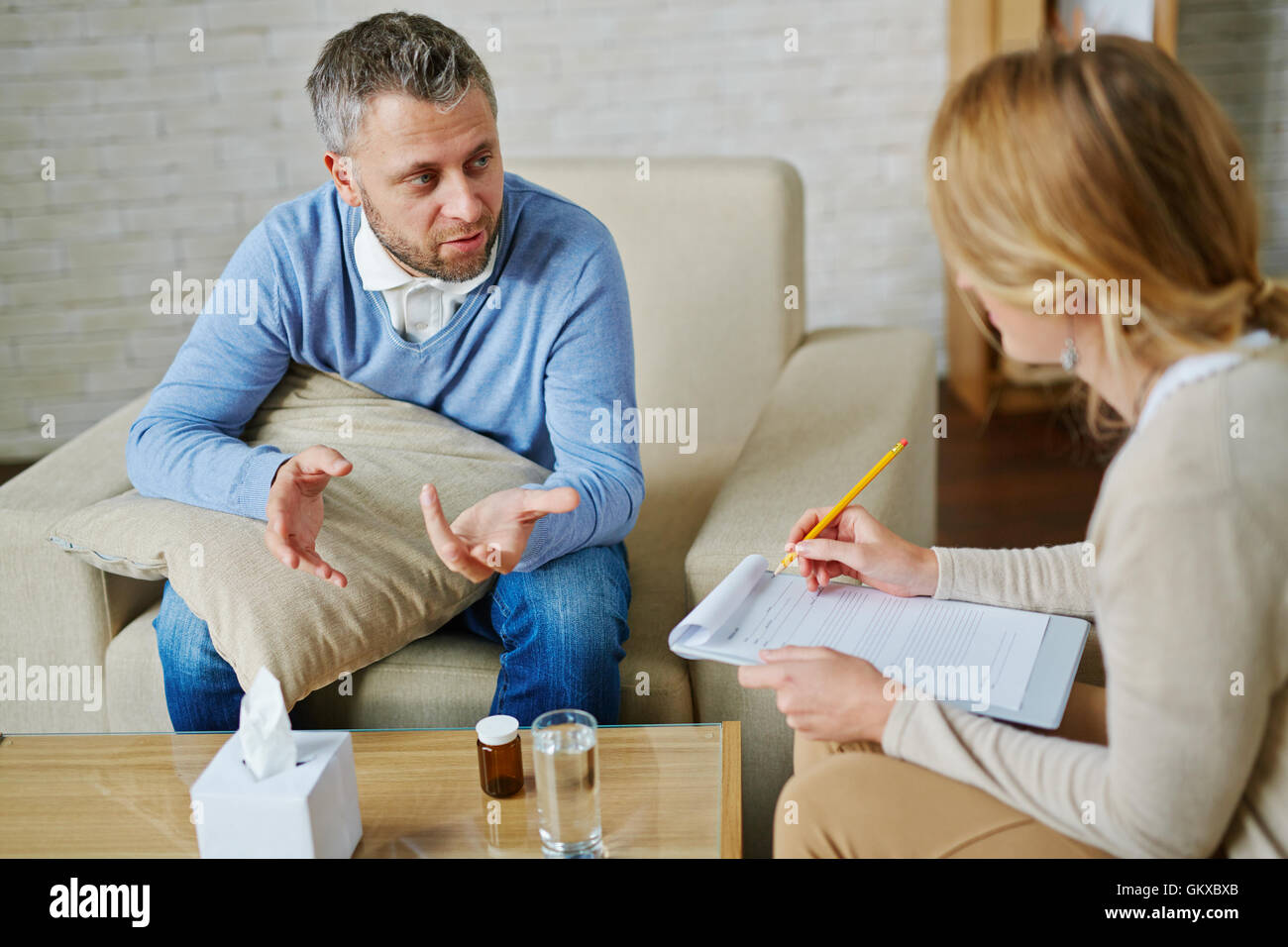 Man explaining his psychological problem to doctor Stock Photo - Alamy