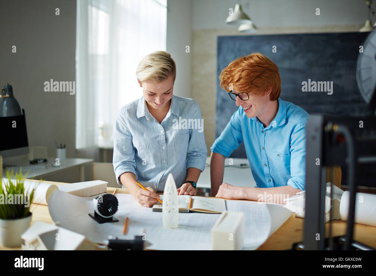 Modern architects discussing new project Stock Photo - Alamy