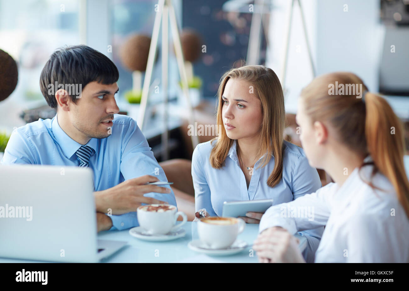 Businessman sharing ideas with his colleagues Stock Photo - Alamy