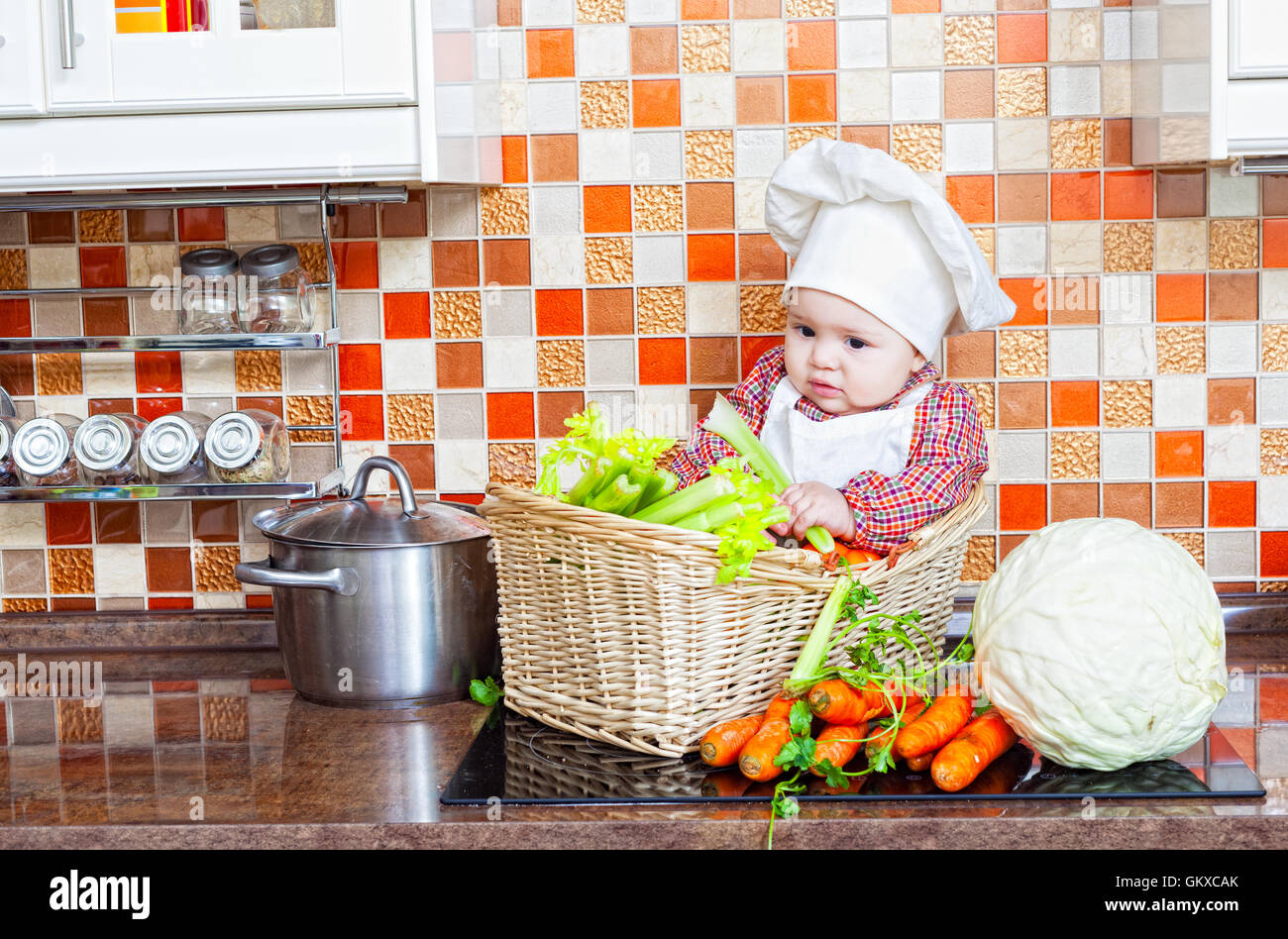 Baby cook with vegetables Stock Photo - Alamy