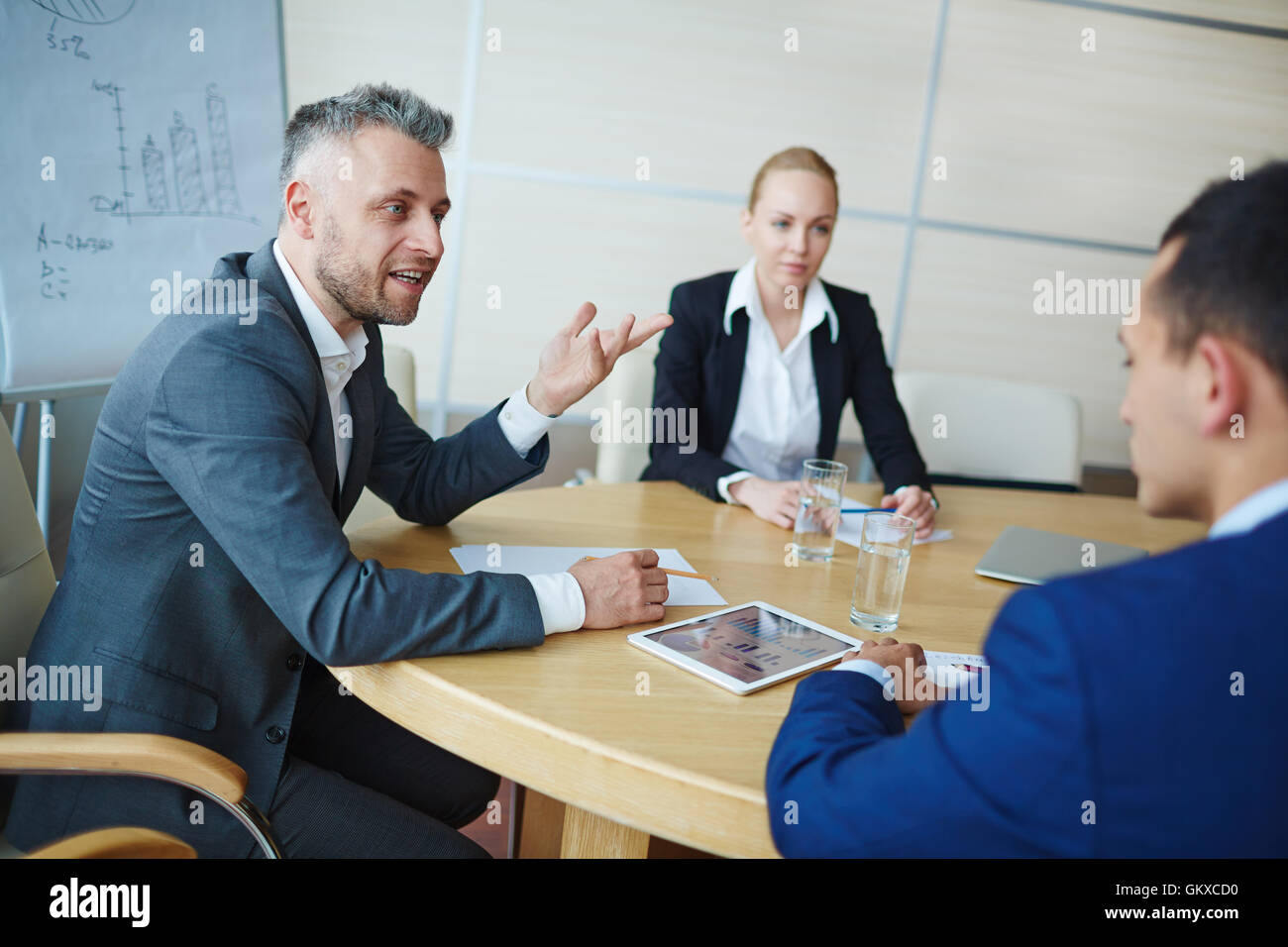 Employer explaining his managers new project Stock Photo - Alamy